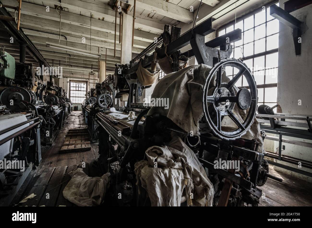 large machine hall in abandoned old spinning mill Stock Photo - Alamy