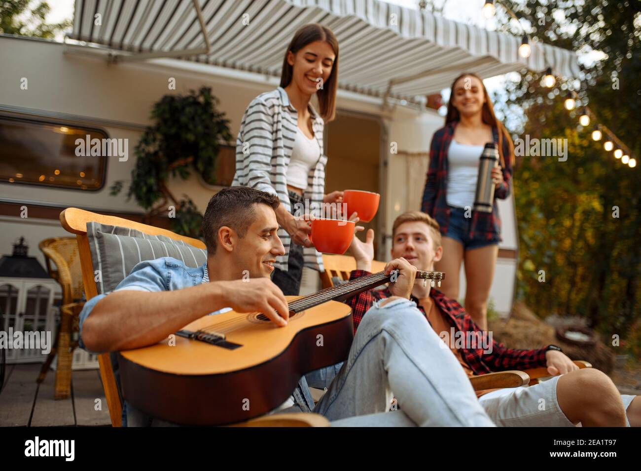 Friends sing songs with guitar, picnic at camping Stock Photo - Alamy