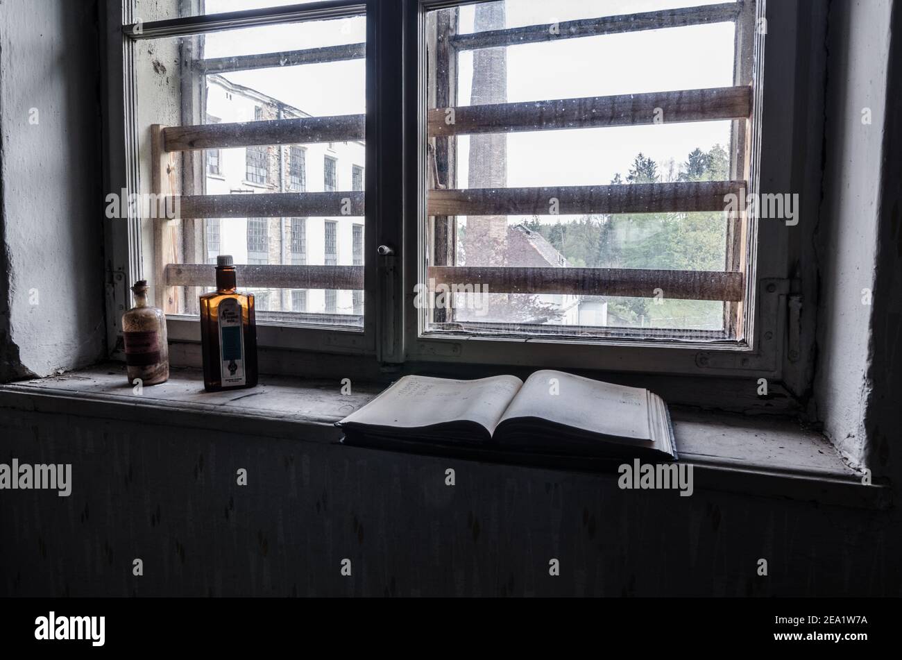 window with book and bottle in factory Stock Photo - Alamy