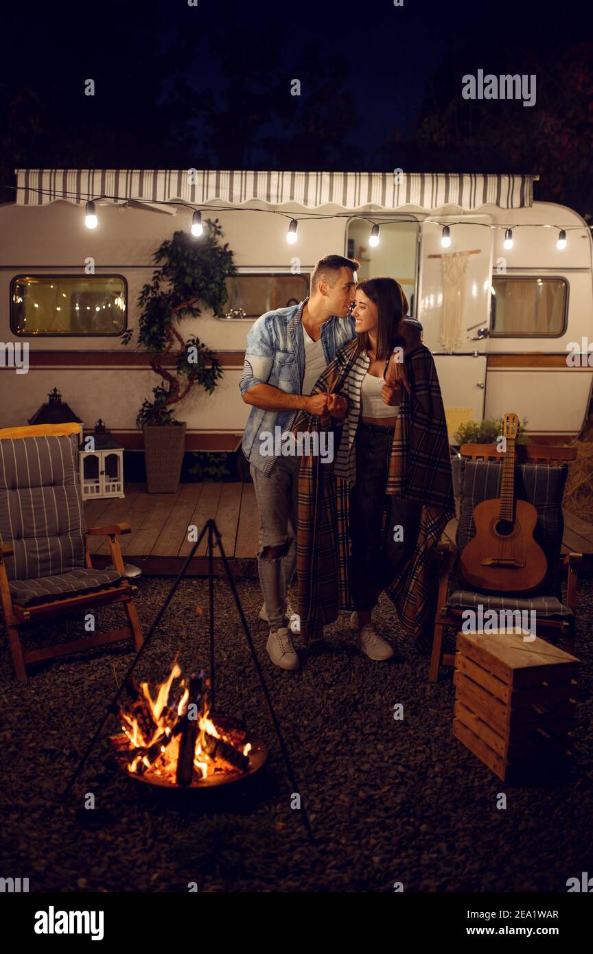 Young love couple kissing by the campfire, camping Stock Photo - Alamy