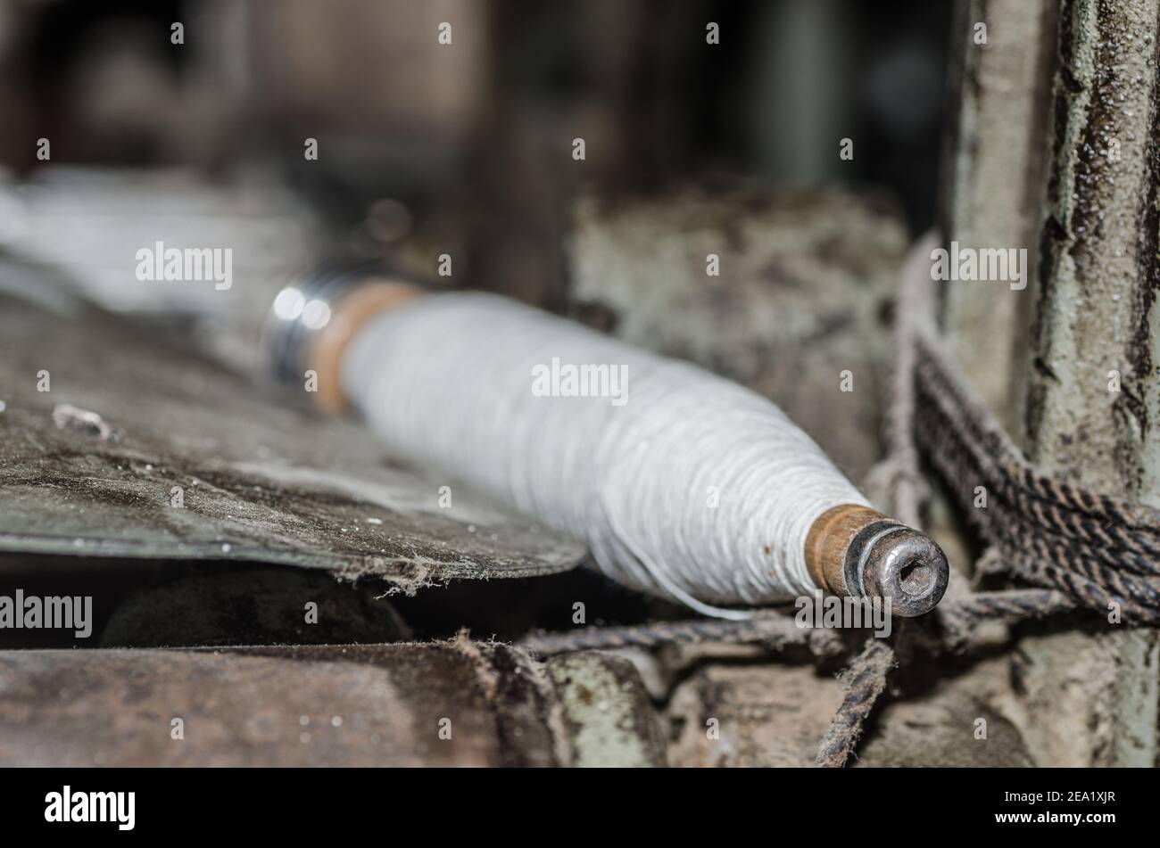 spindle with white yarn on a machine Stock Photo - Alamy