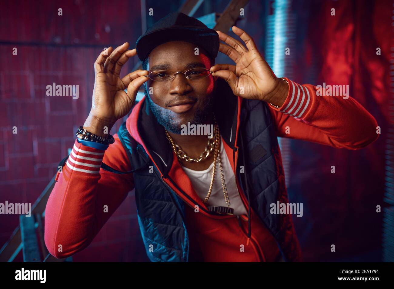 Rapper in stylish gold glasses posing in studio Stock Photo - Alamy