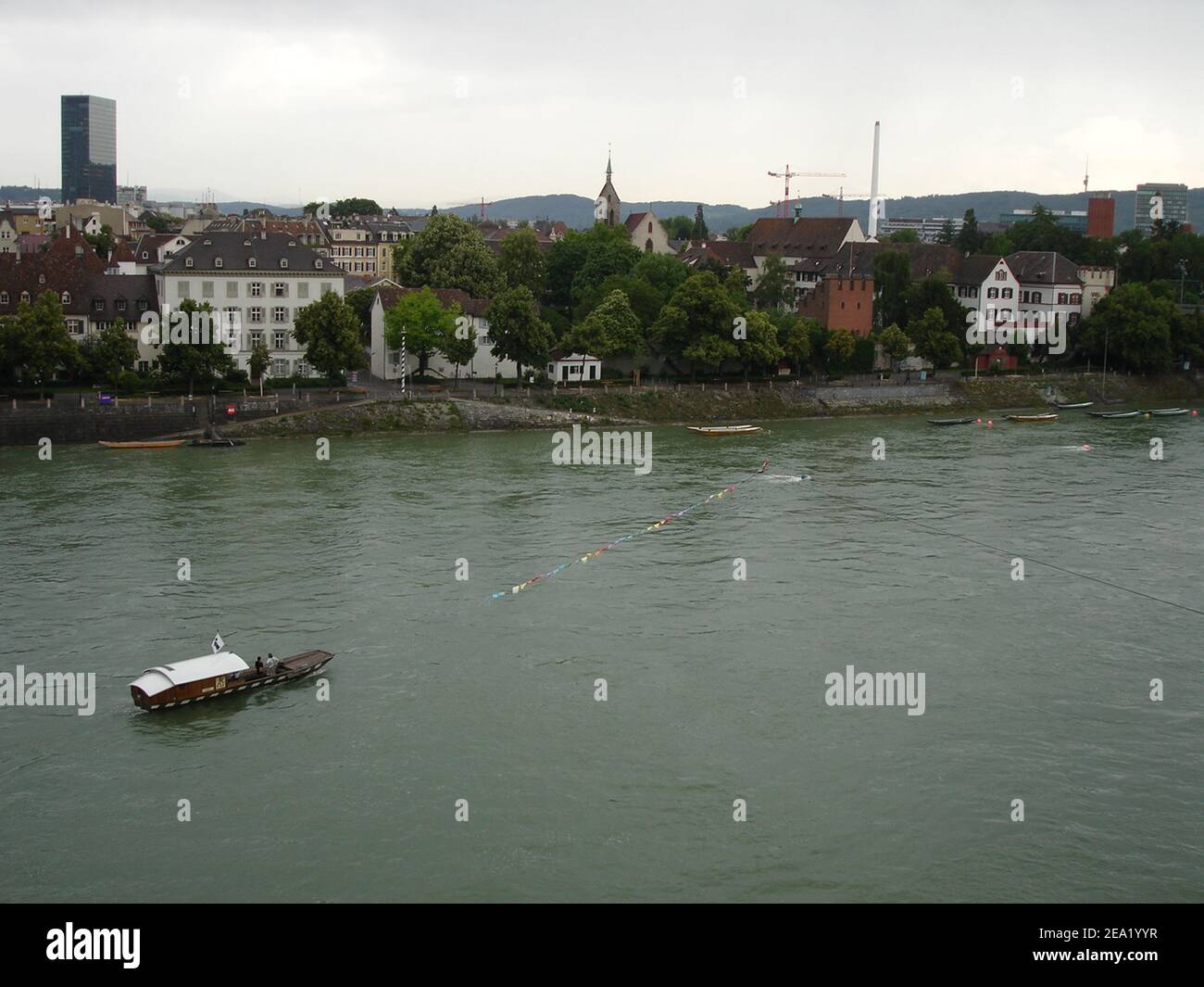 Rhine crossing in Basel by small ferries manually pulled against the ...