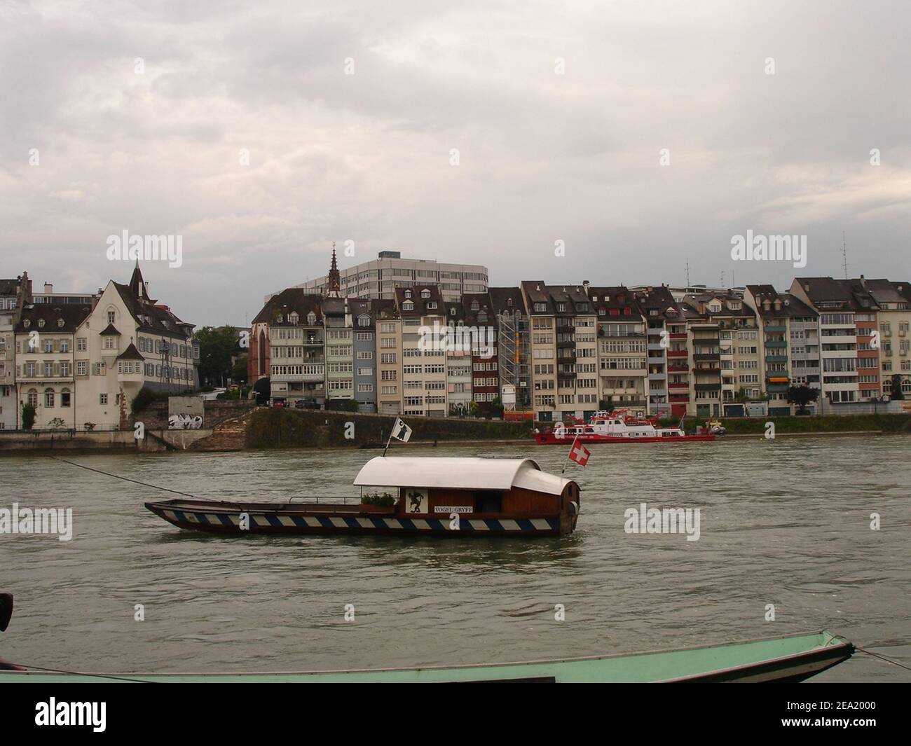 Rhine crossing in Basel by small ferries manually pulled against the ...
