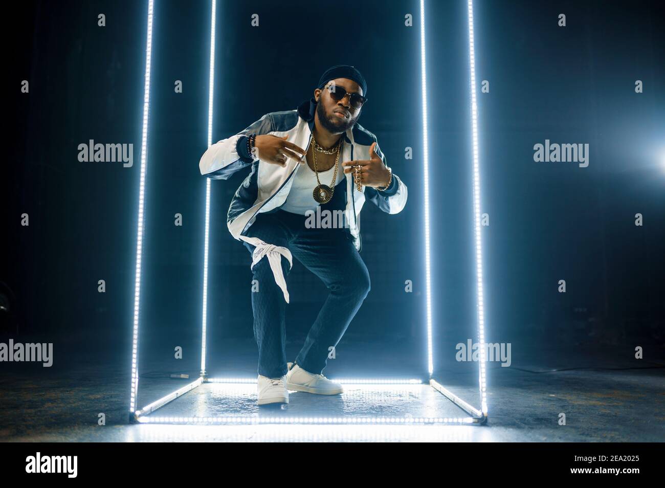 Stylish rapper in gold jewelry and sunglasses Stock Photo - Alamy