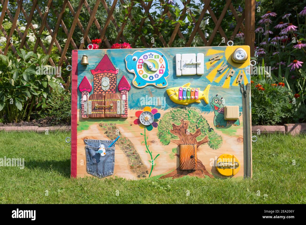 homemade montessori baby's toy dashboard on background green lawn in ...