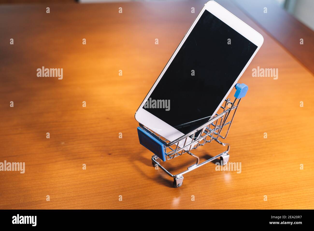 Smartphone inside a small shopping cart, online shopping concept Stock ...