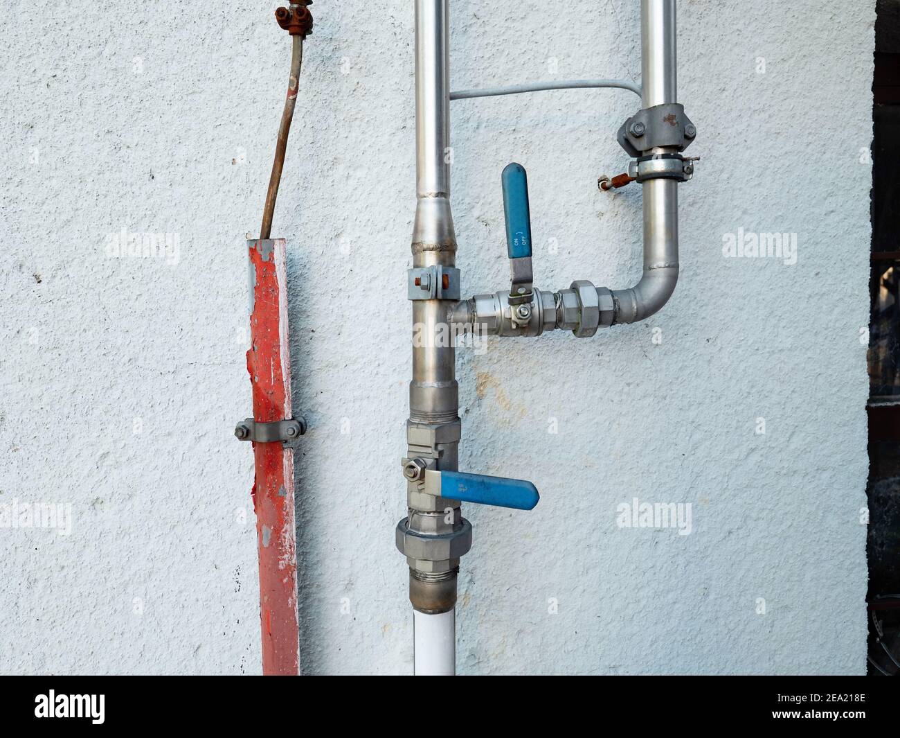 Stainless tube with thin branche and two open close ball valves. The ...