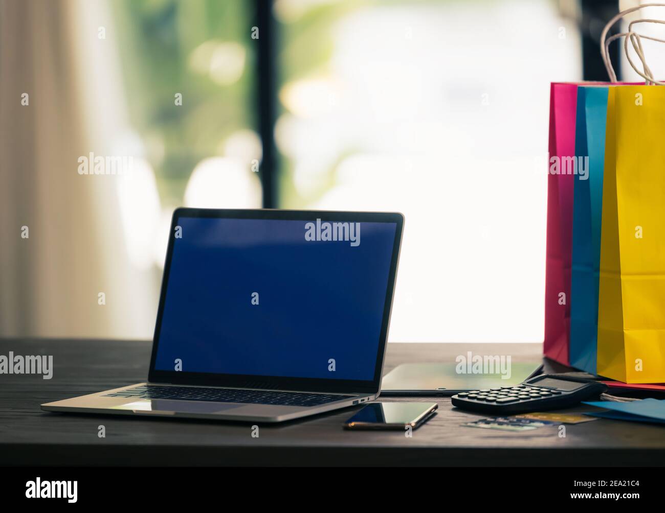 Laptop with blank blue screen on table Stock Photo - Alamy