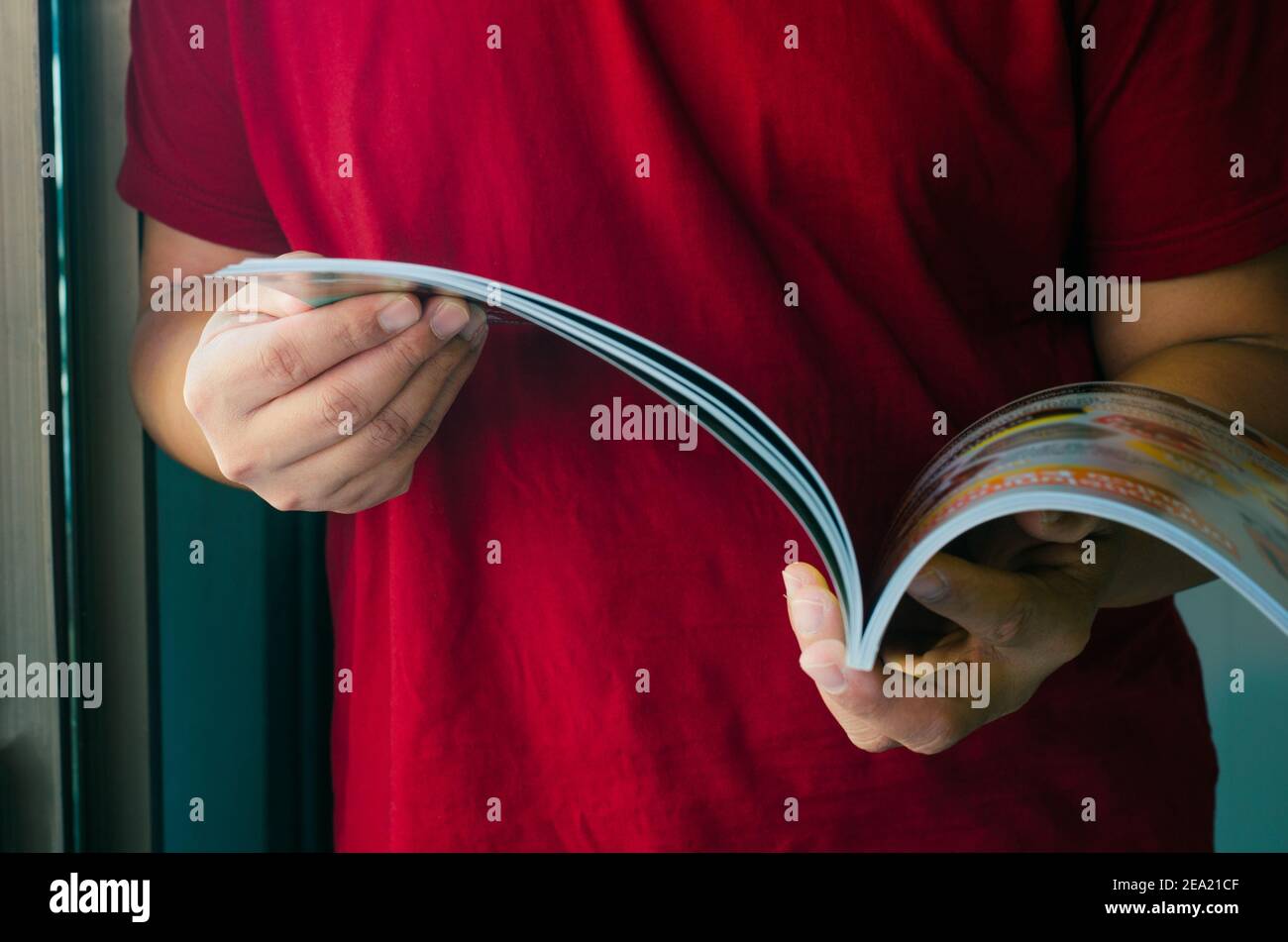 Man standing reading book image focus Stock Photo - Alamy