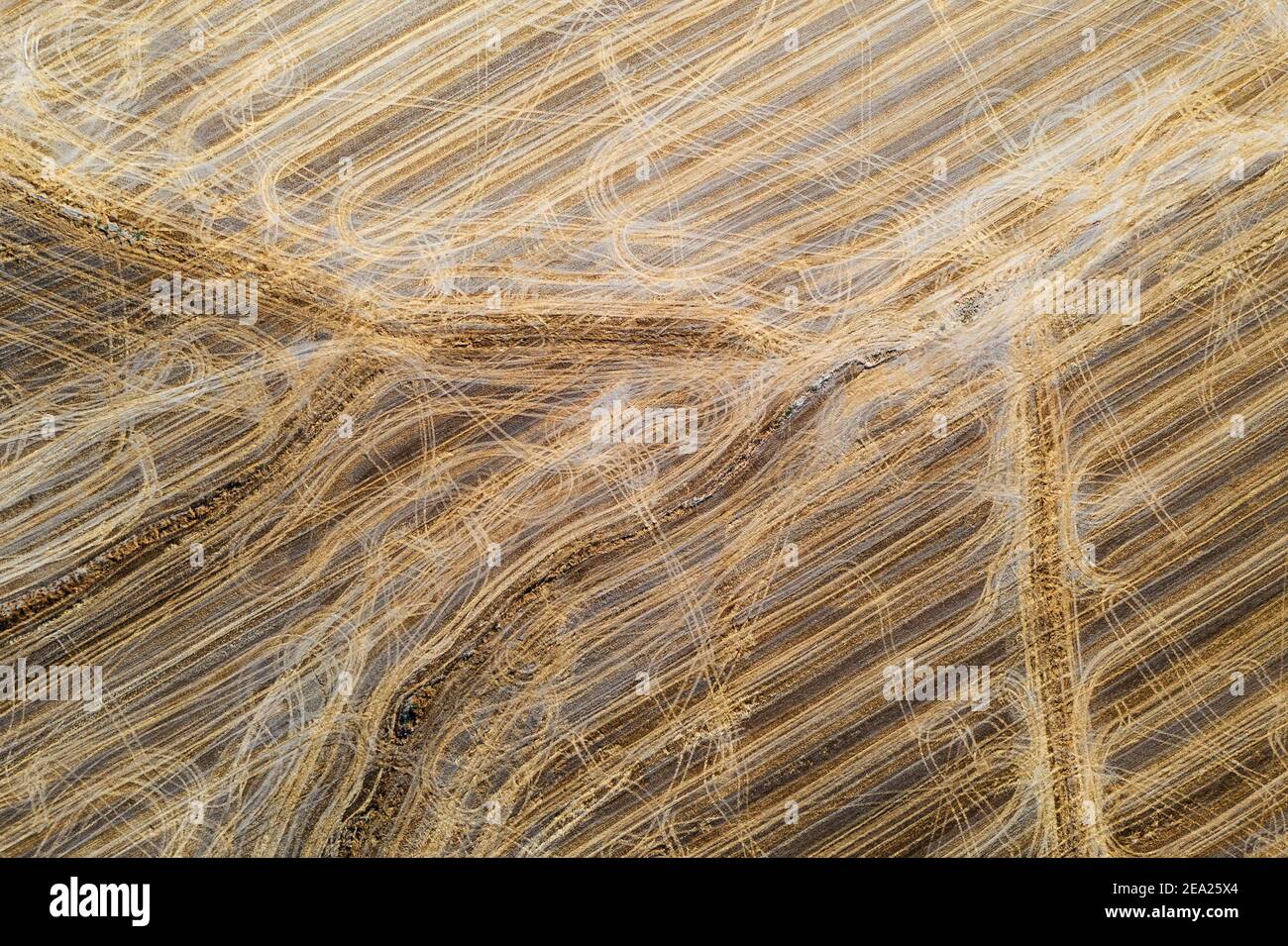 Abstract patterns caused by tractor wheel ruts in cornfield after wheat ...
