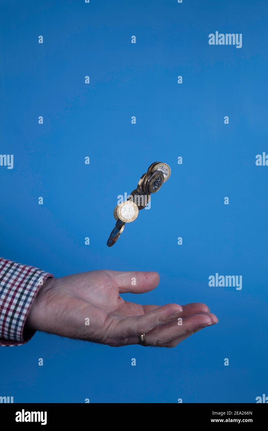 A hand dropping coins hi-res stock photography and images - Alamy