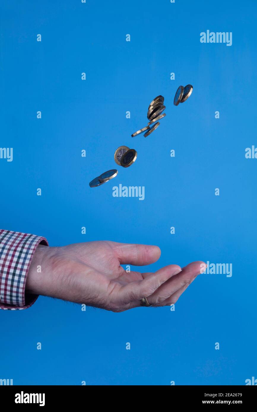 A hand dropping coins hi-res stock photography and images - Alamy