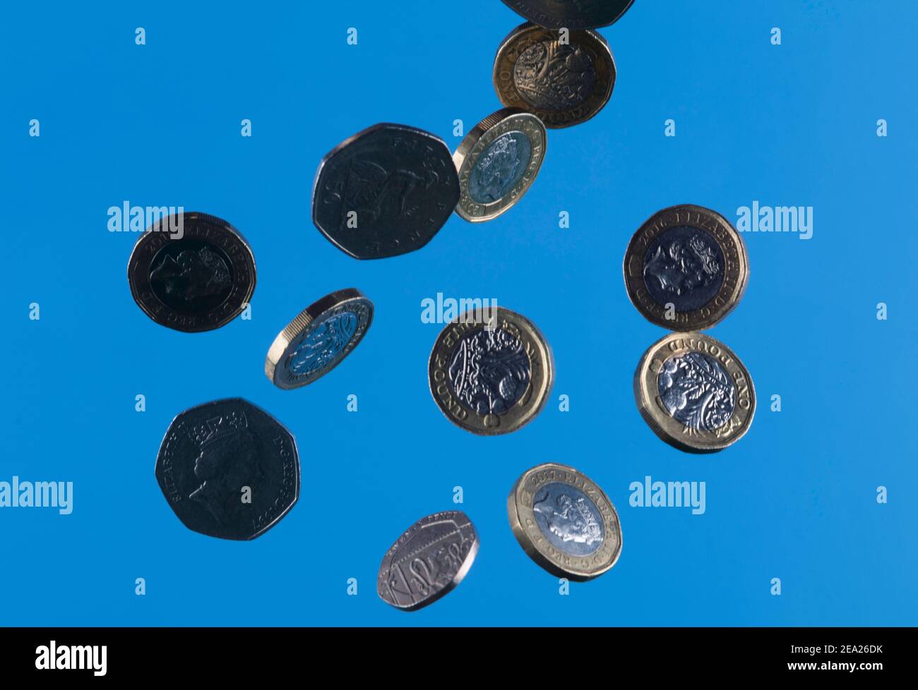 UK coins captured in mid air, falling down Stock Photo - Alamy