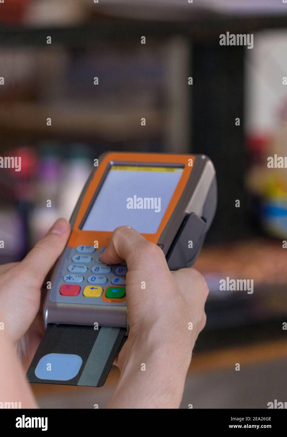 Holding a credit card payment swipe machine in a Restaurant Stock Photo ...