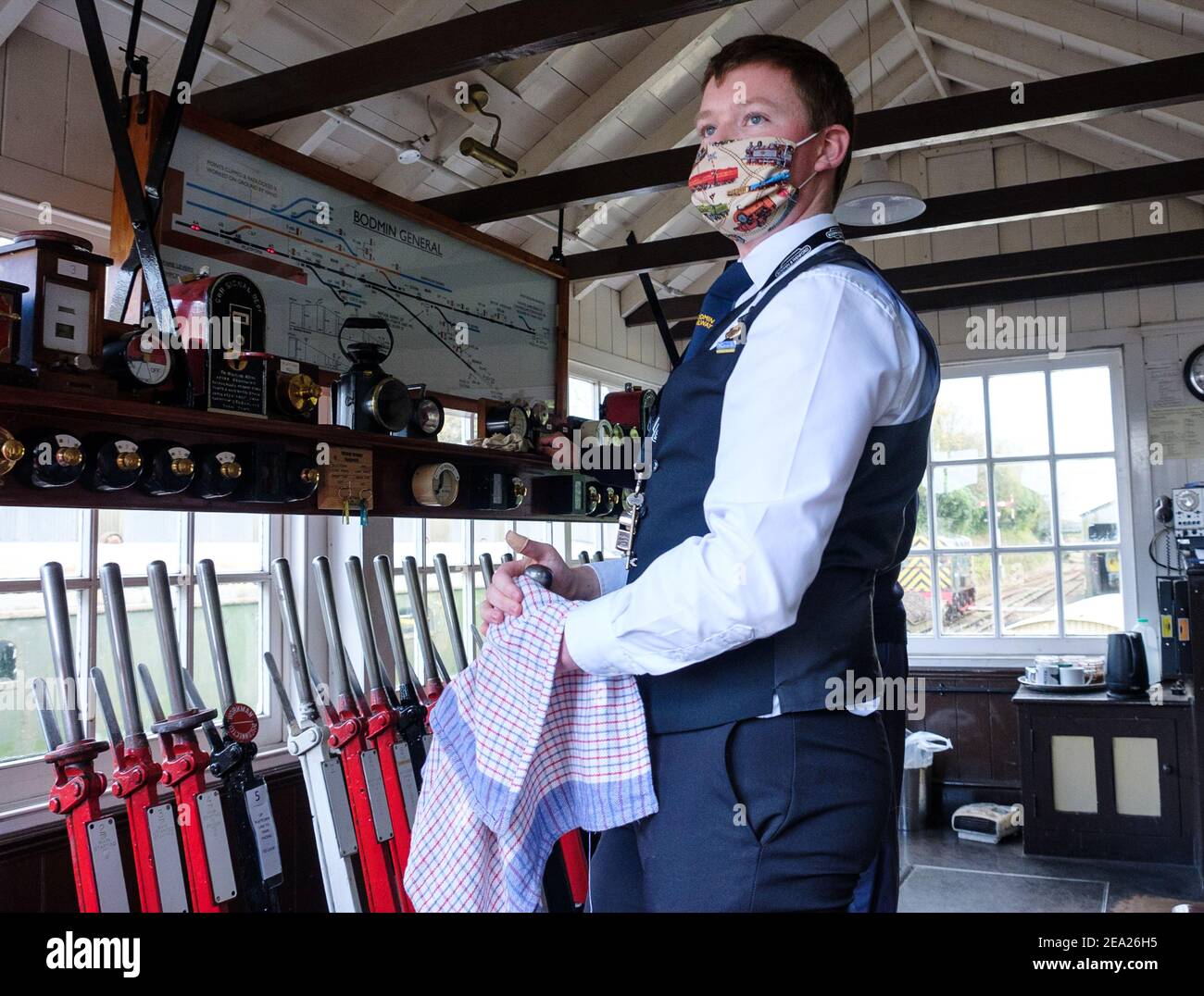 Young man, Covid 19 masked employed as historic railway signalman ...