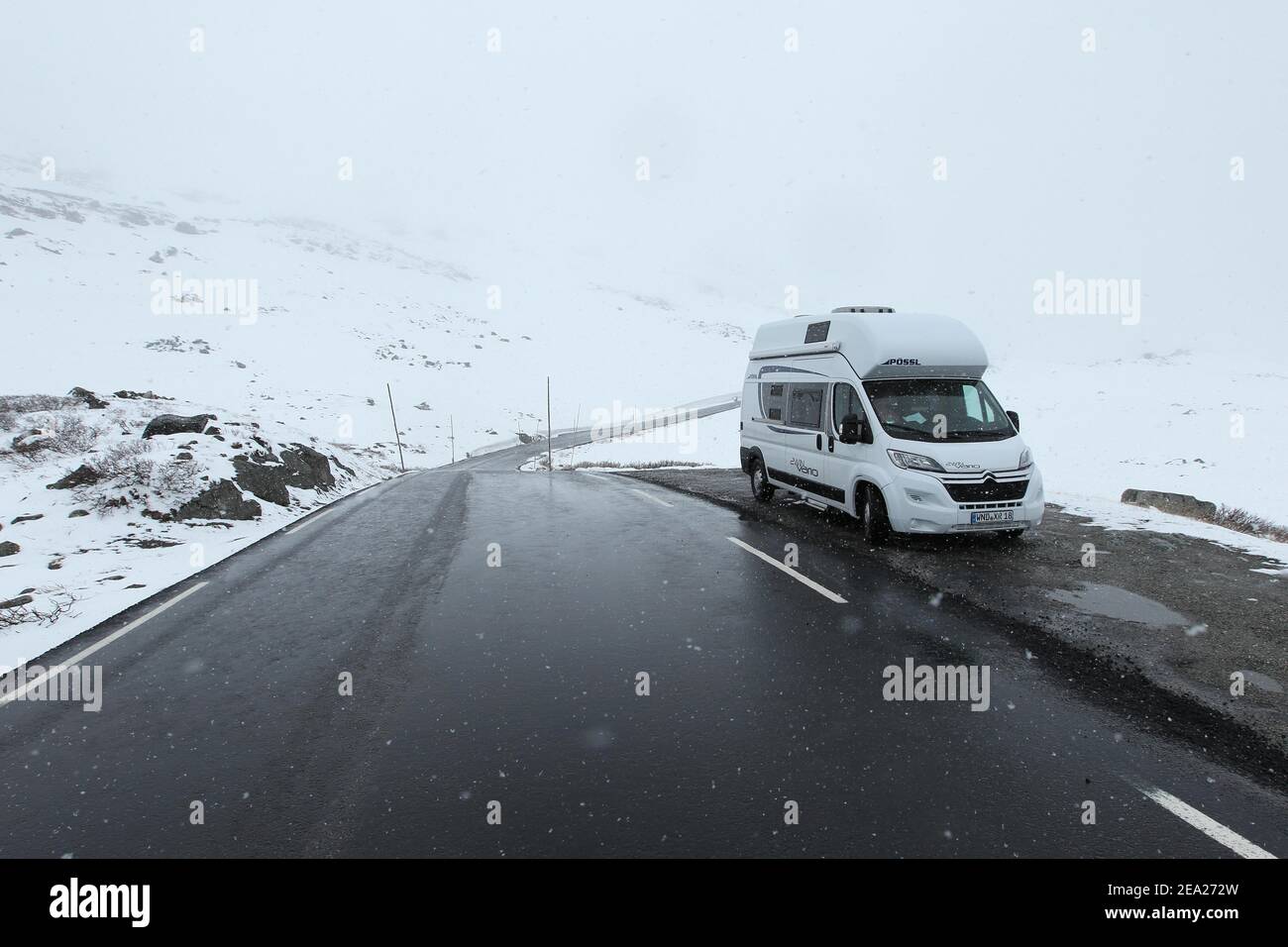 Motorhome, camper, in the snow during snowfall, Hardanger Vidda plateau ...