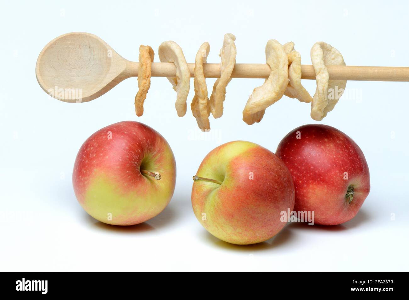 Apples and apple rings on wooden spoon Stock Photo - Alamy