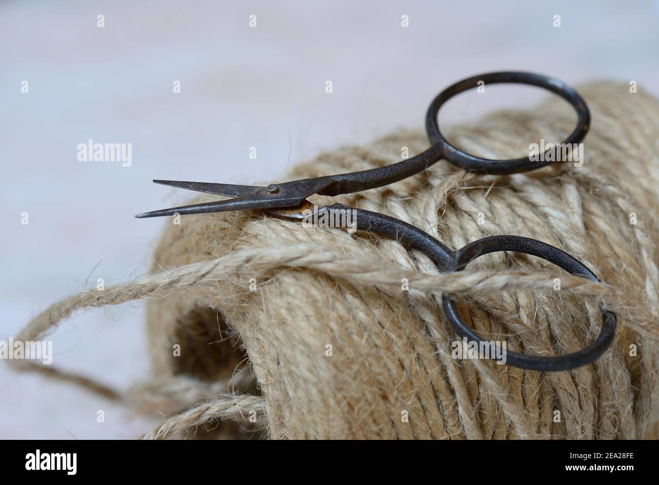 Roll of jute string and scissors, jute thread, jute Stock Photo - Alamy