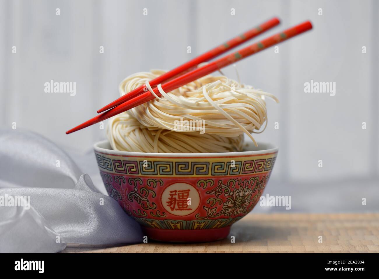 Chinese Yangchun noodles in bowl with chopsticks, uncooked, nest ...