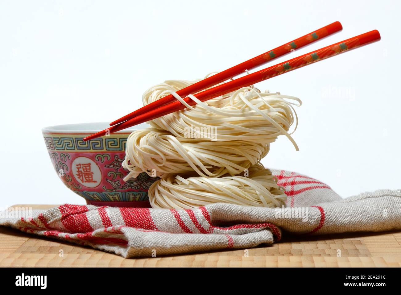 Chinese Yangchun noodles with chopsticks, uncooked, nest noodles Stock ...