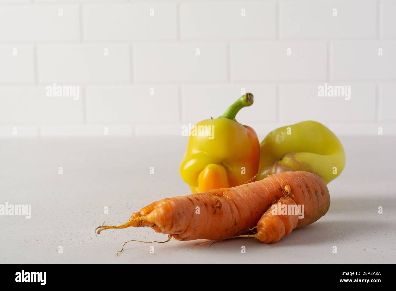 Two ugly peppers and carrots that looks like a strange face on a light ...