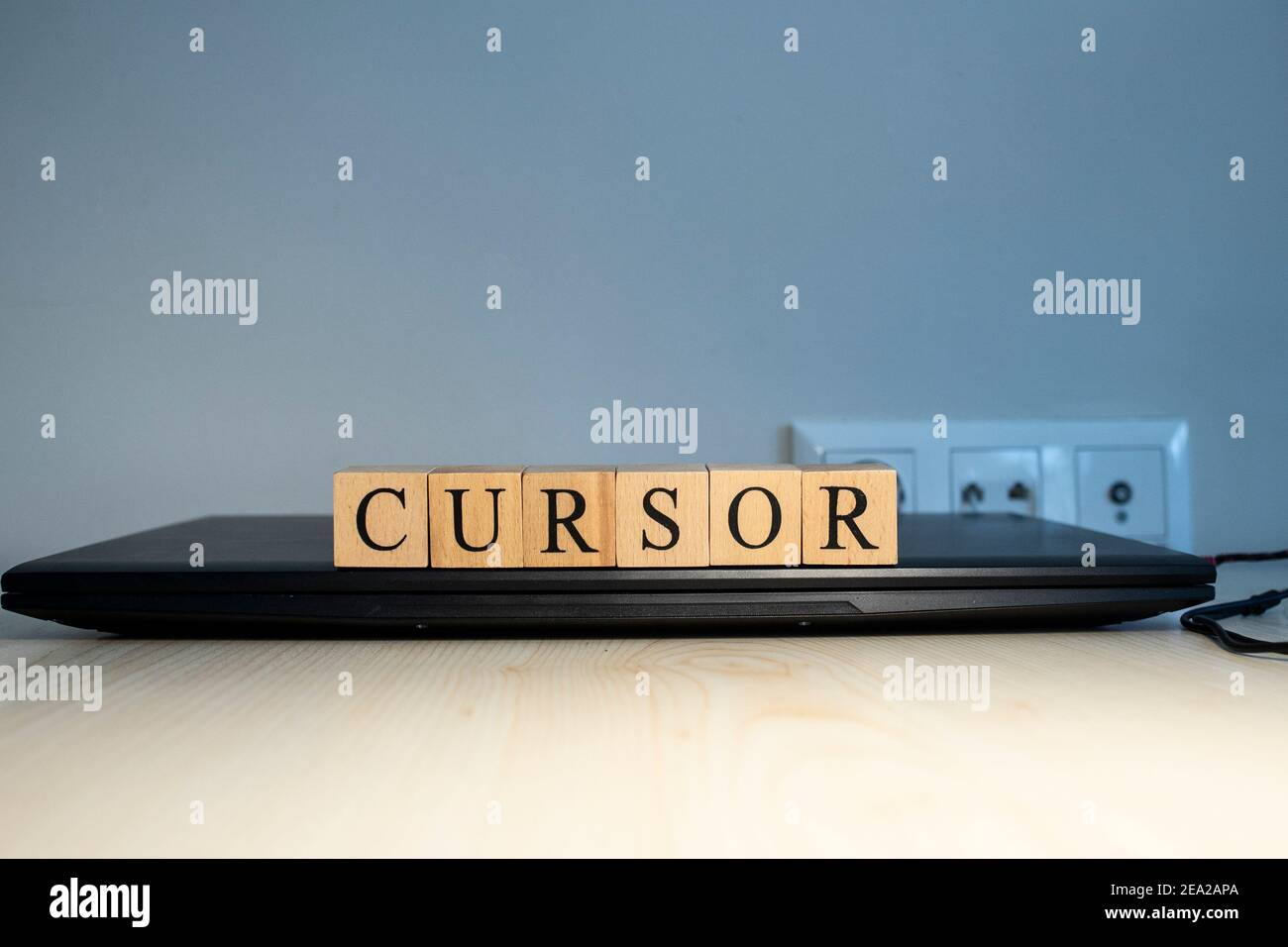 The word cursor is written. Computer and headset in the background ...