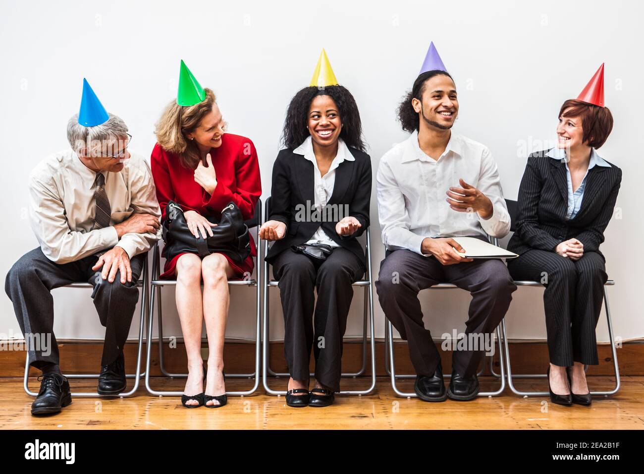 A group of business people wearing party hats Stock Photo - Alamy