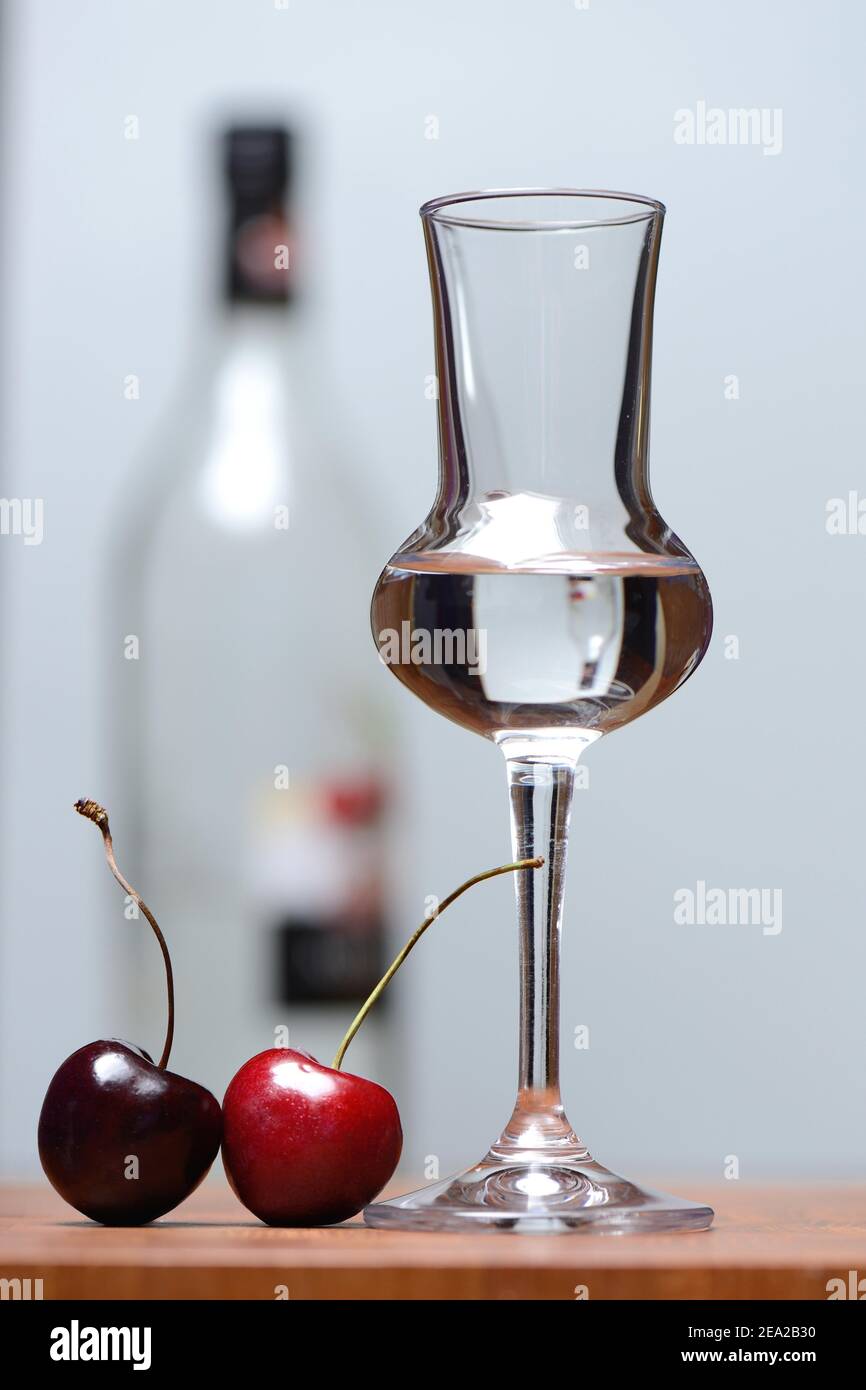 Glass of cherry brandy with cherries Stock Photo - Alamy