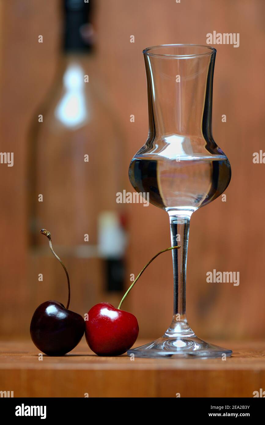 Glass of cherry brandy with cherries Stock Photo - Alamy