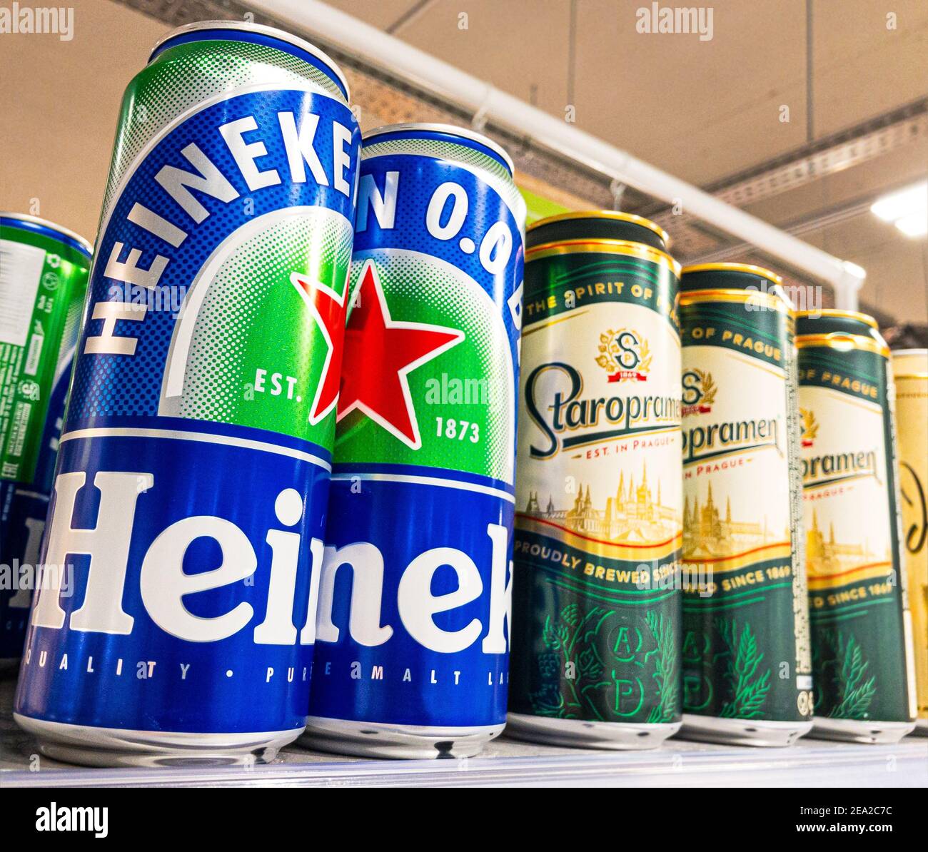2021: Heineken and Staropramen beers in tin cans standing in ...