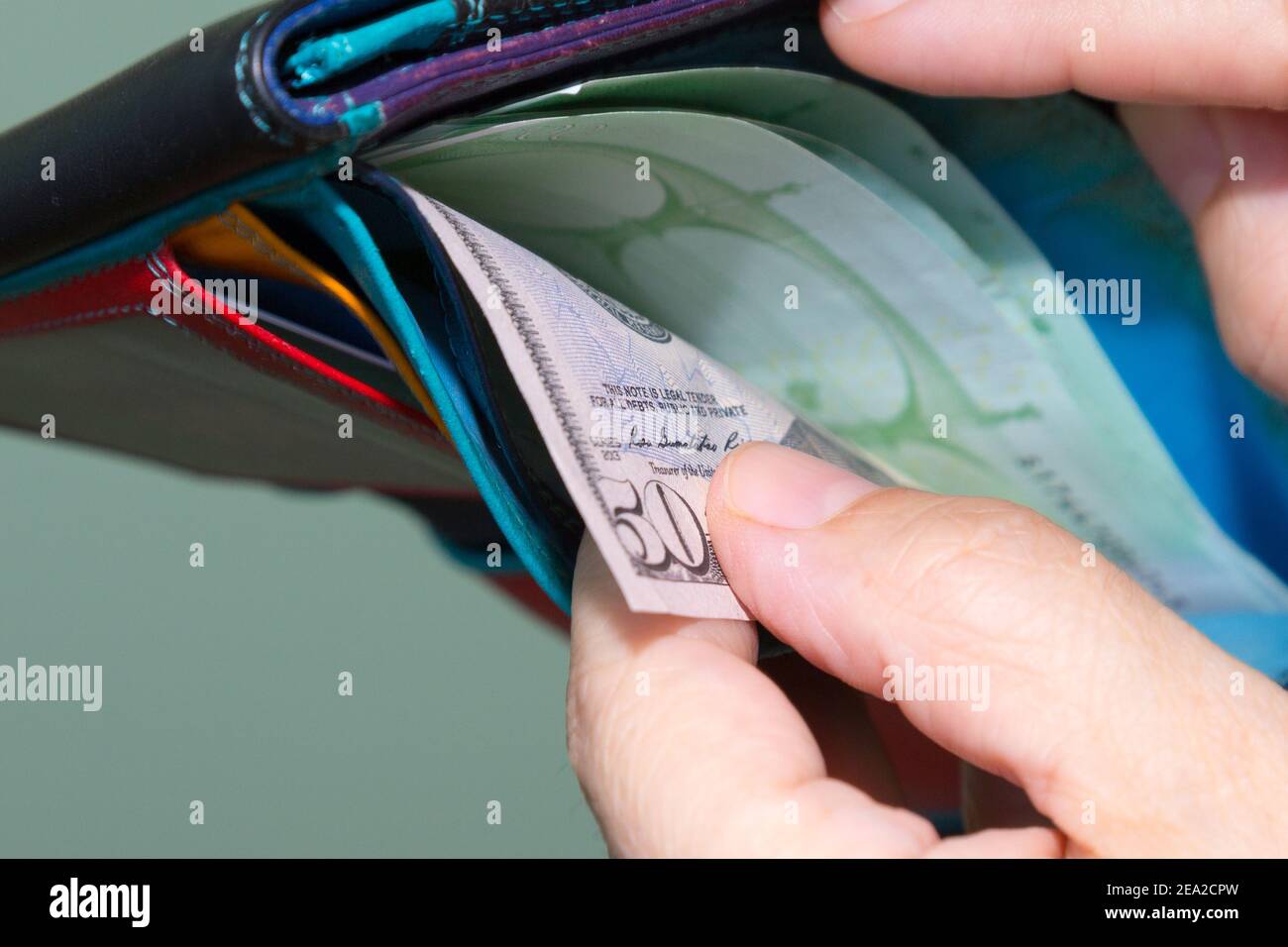 Close up of hands pulling banknotes 50 dollar out of wallet Stock Photo ...