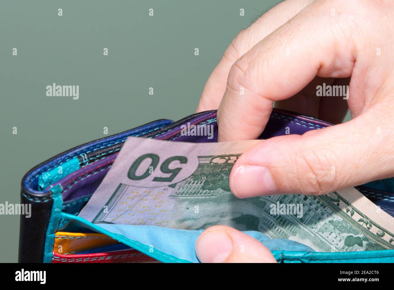 The hands pulling banknotes 50 dollar out of wallet. Concept payments ...