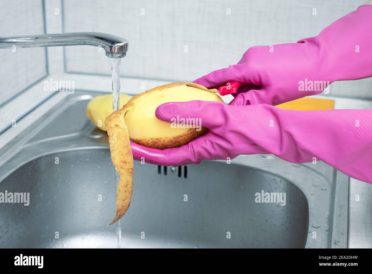 Person washing peeling fresh potato hi-res stock photography and images ...