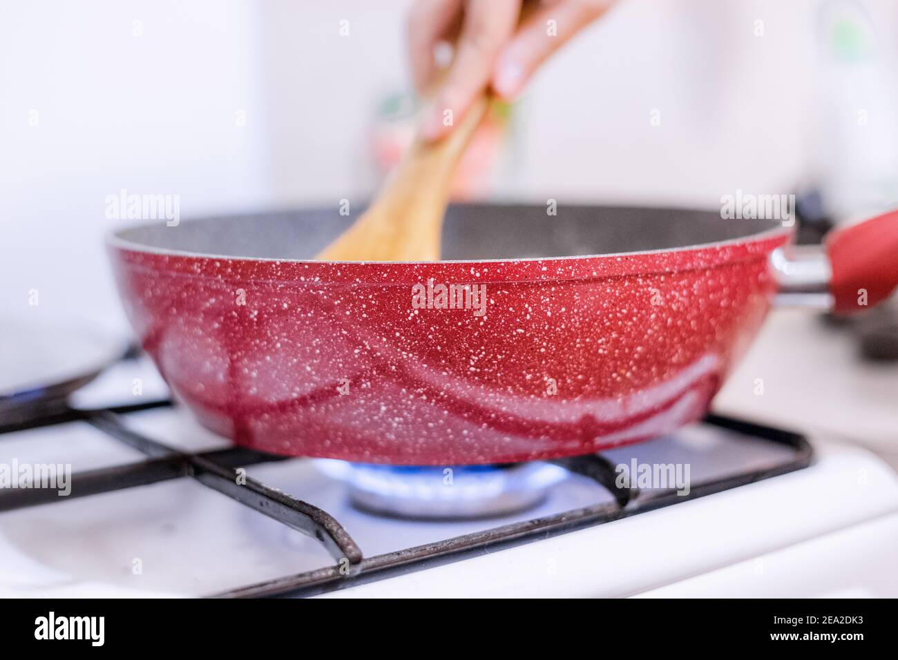 Close-up of the gas stove fire. Cooking food in a frying pan. Concept ...