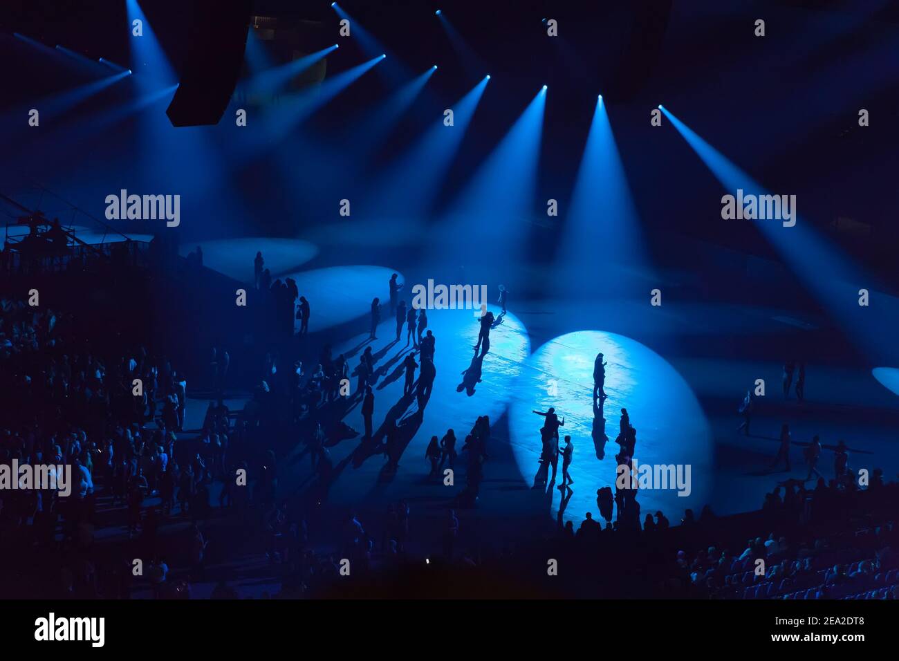 Silhouettes Crowds of people are under spotlights in blue color. People ...