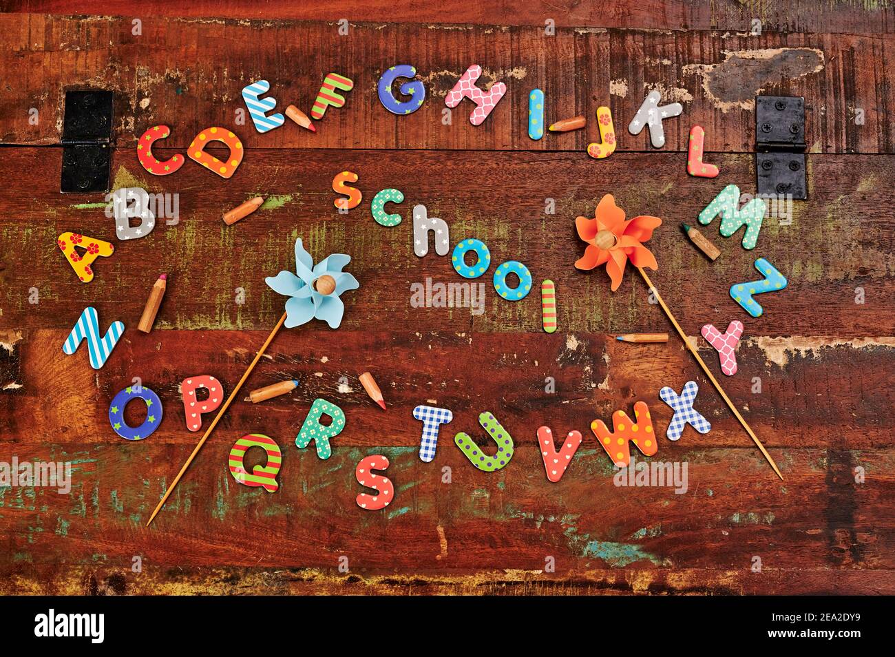Auburn wooden table with colorful letters that show the alphabet lying ...