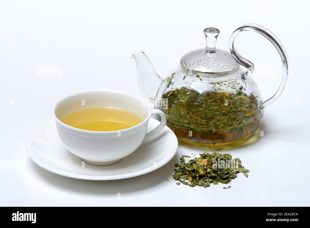 Moringa tea in cup and teapot and moringa leaves, moringa tea Stock ...