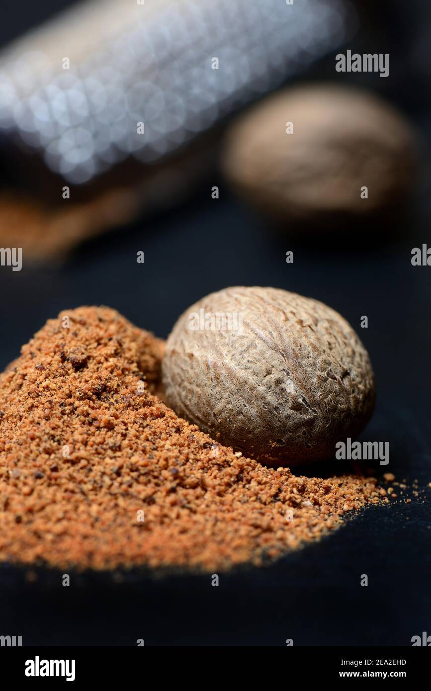 Nutmegs and nutmeg powder, ground, grated Stock Photo - Alamy