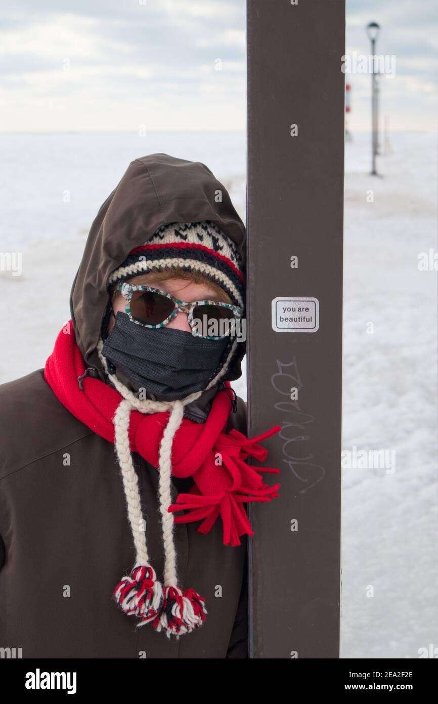 A masked female dressed for an extremely cold day.She was photographed ...