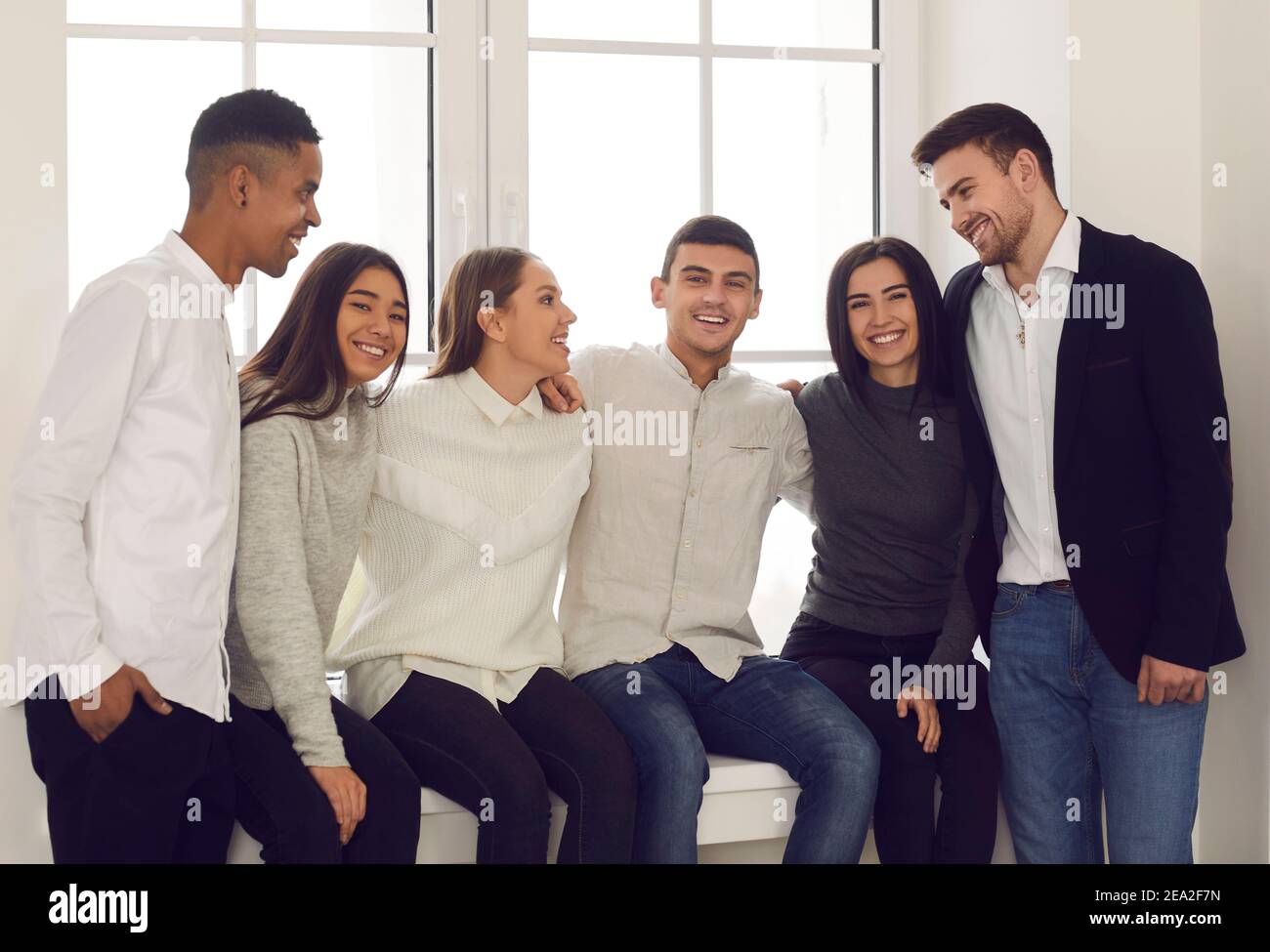 Group of happy young friends, coworkers or students gathered by the ...