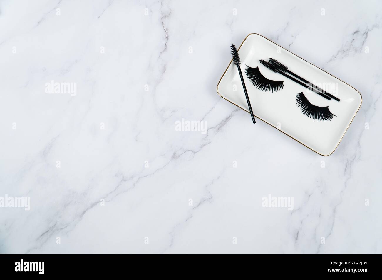 Eyelashes beauty background set on white grey marble with plenty of ...