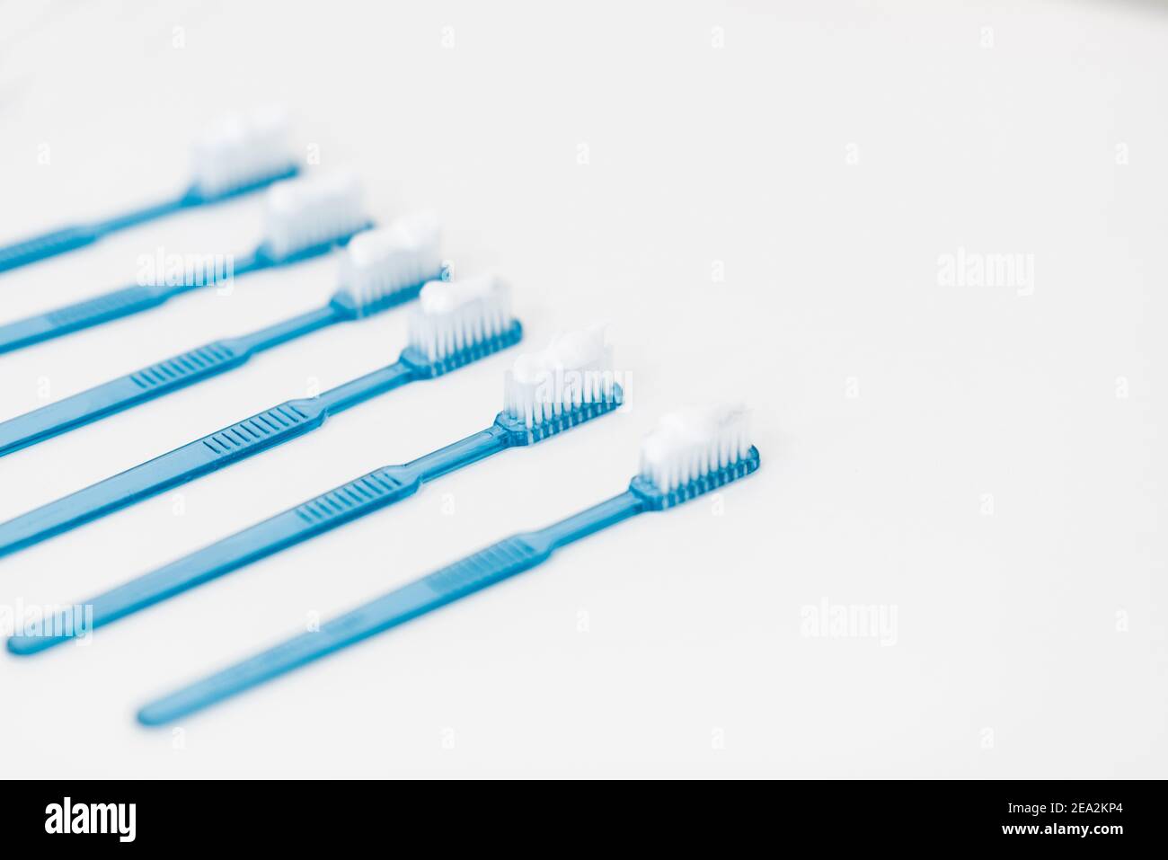 Plastic blue toothbrushes with toothpaste isolated on a white ...