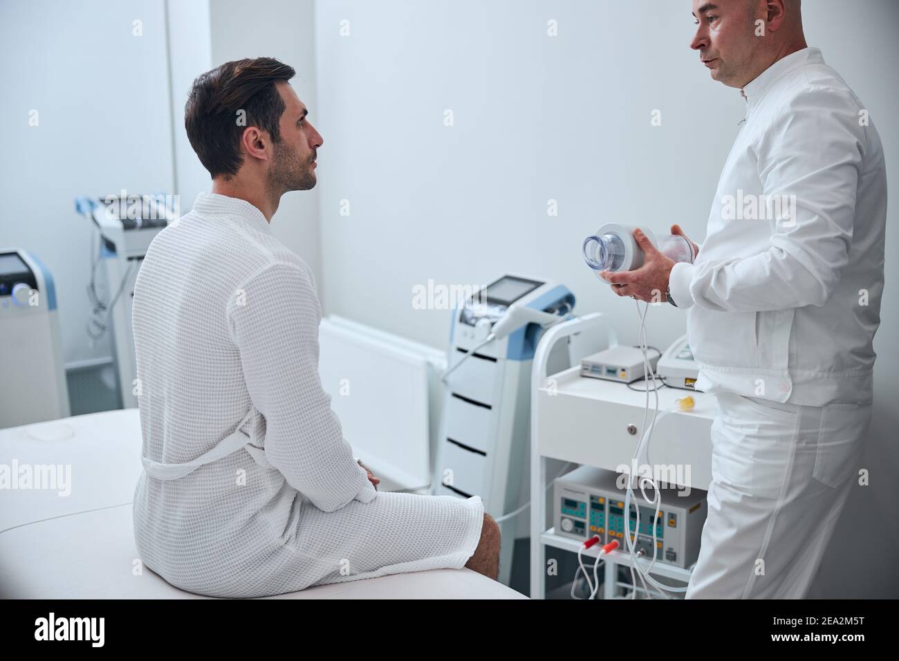 Handsome man visiting hospital for diagnosis with modern technology ...