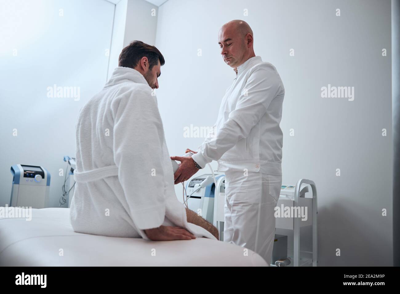 Doctor doing medical visit treatment hi-res stock photography and ...
