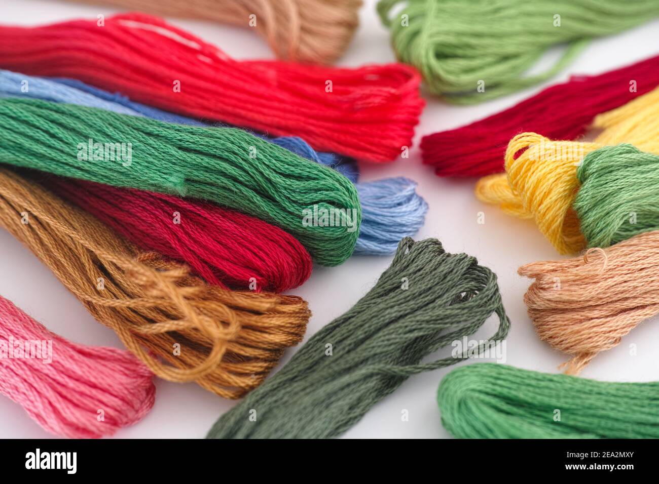 Colorful cross stitch embroidery threads. Close up Stock Photo - Alamy