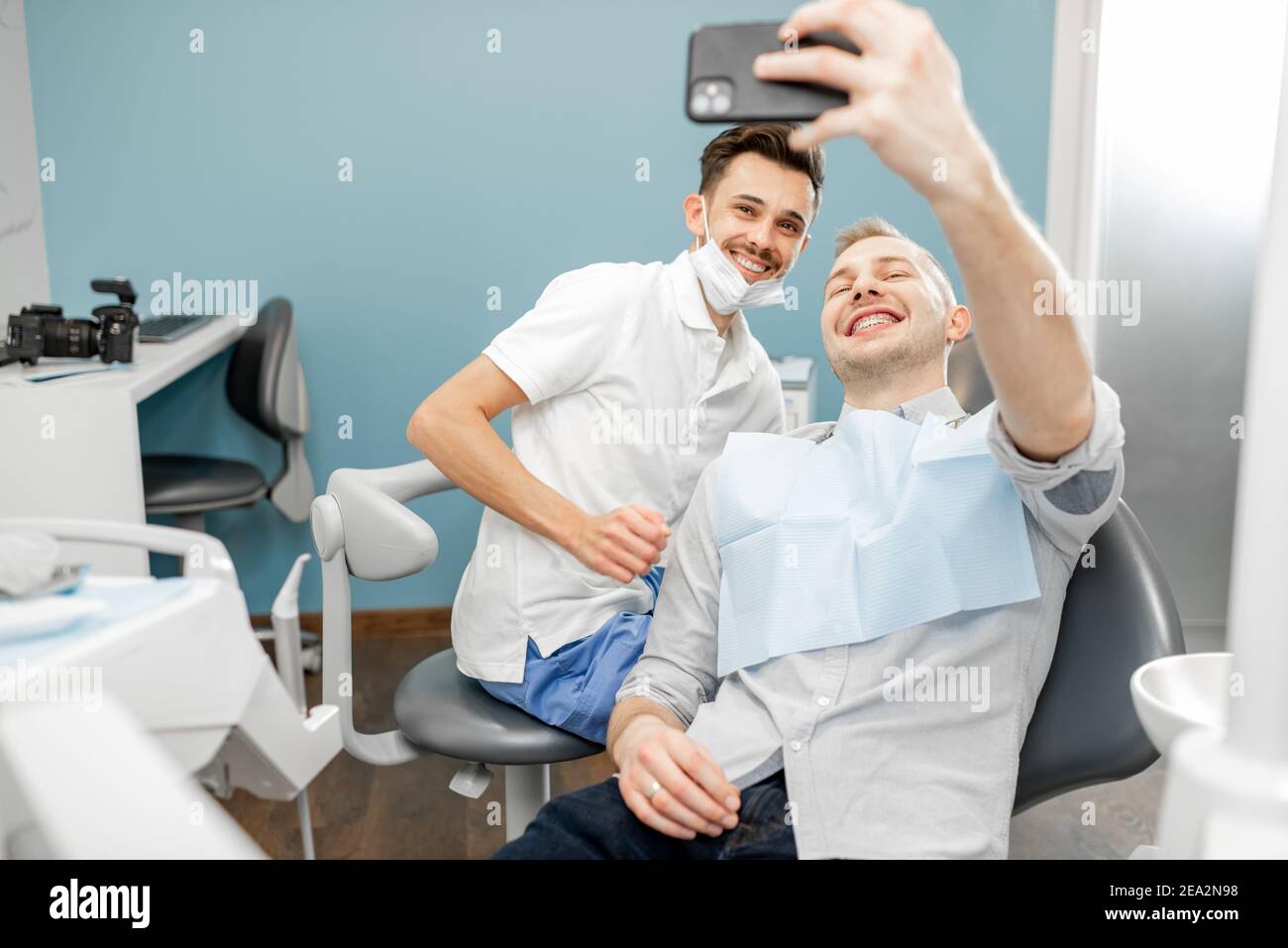Happy patient with a dentist at the dental office Stock Photo - Alamy