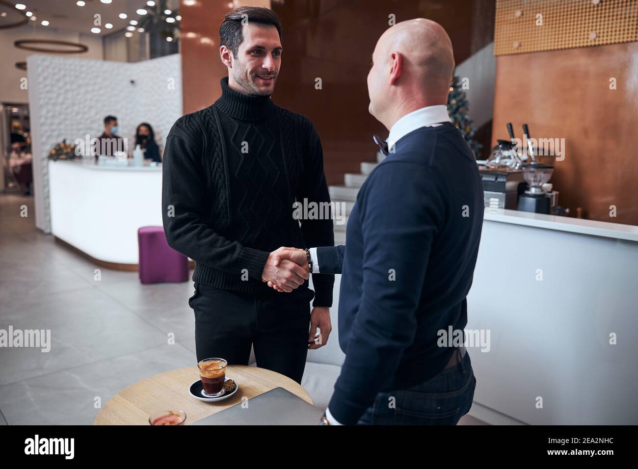 Two happy man shaking hands after making agreement Stock Photo - Alamy