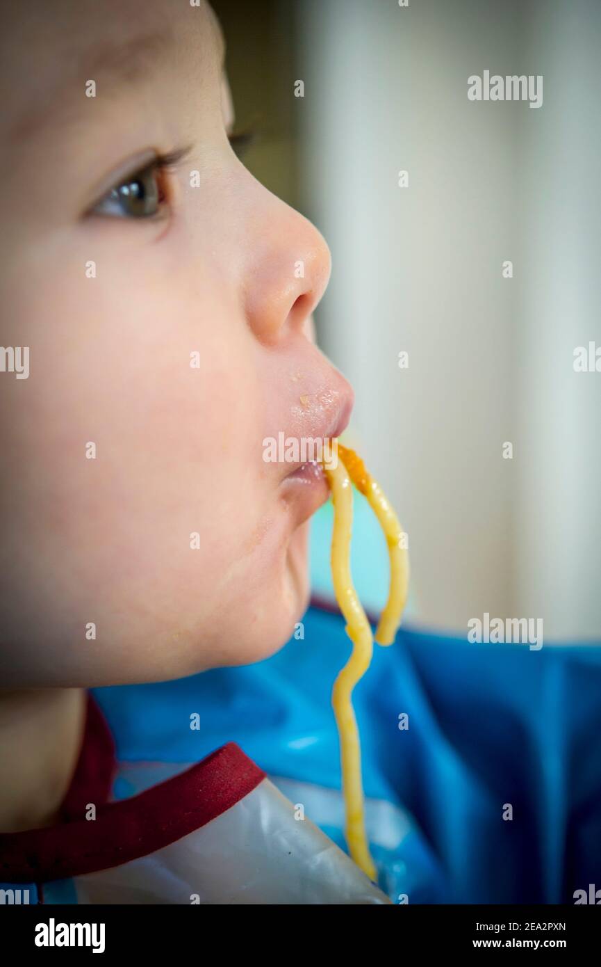 Portrait messy boy eating spaghetti hi-res stock photography and images ...