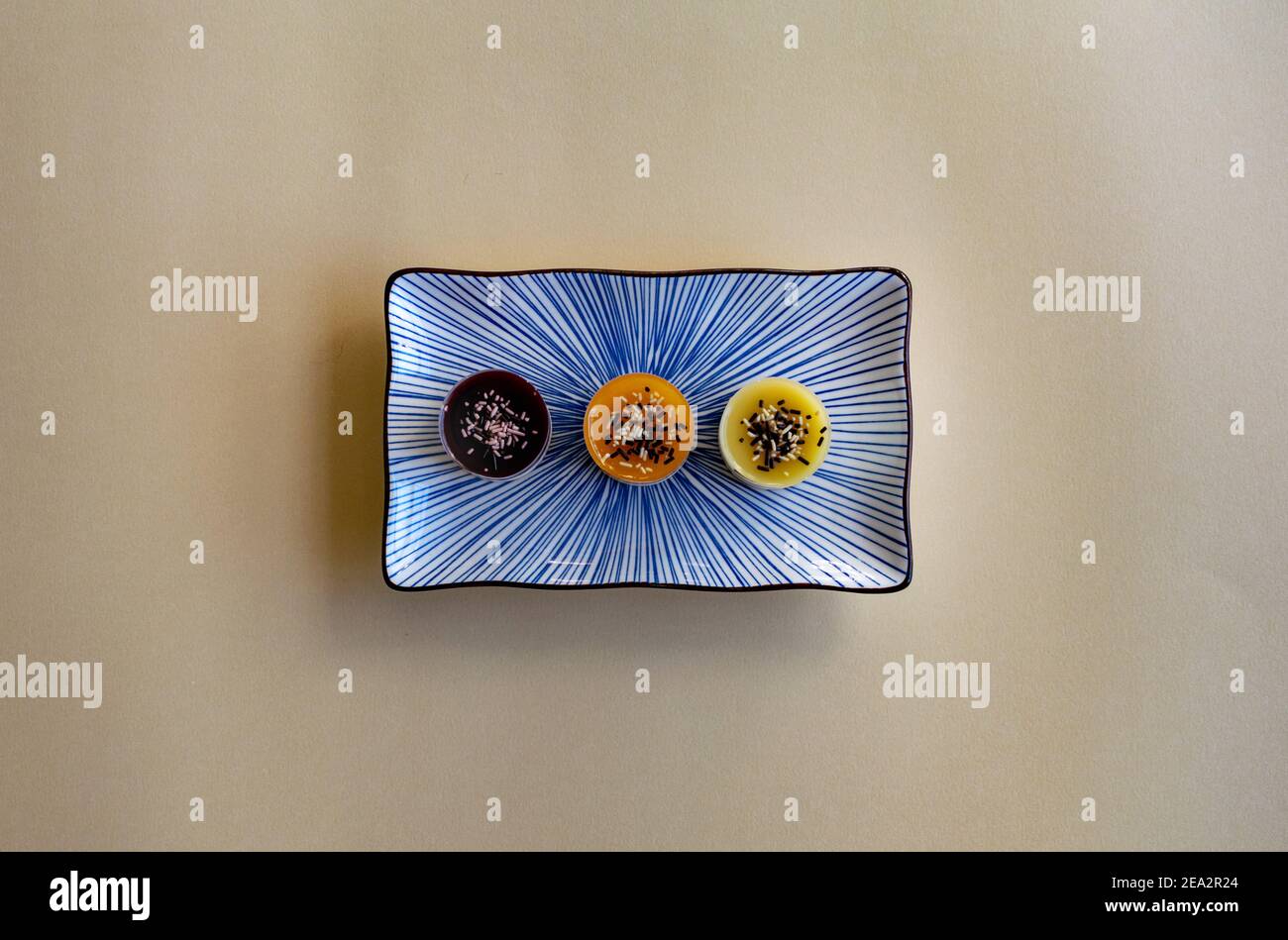 a trio of mini cheesecake desserts in various flavours on a plate Stock ...